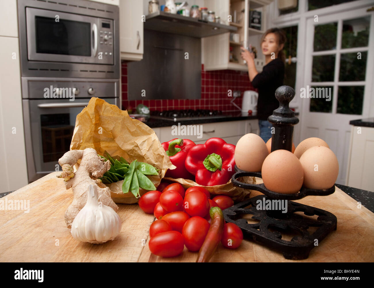 A woman preparing dinner with vegetables Stock Photo - Alamy