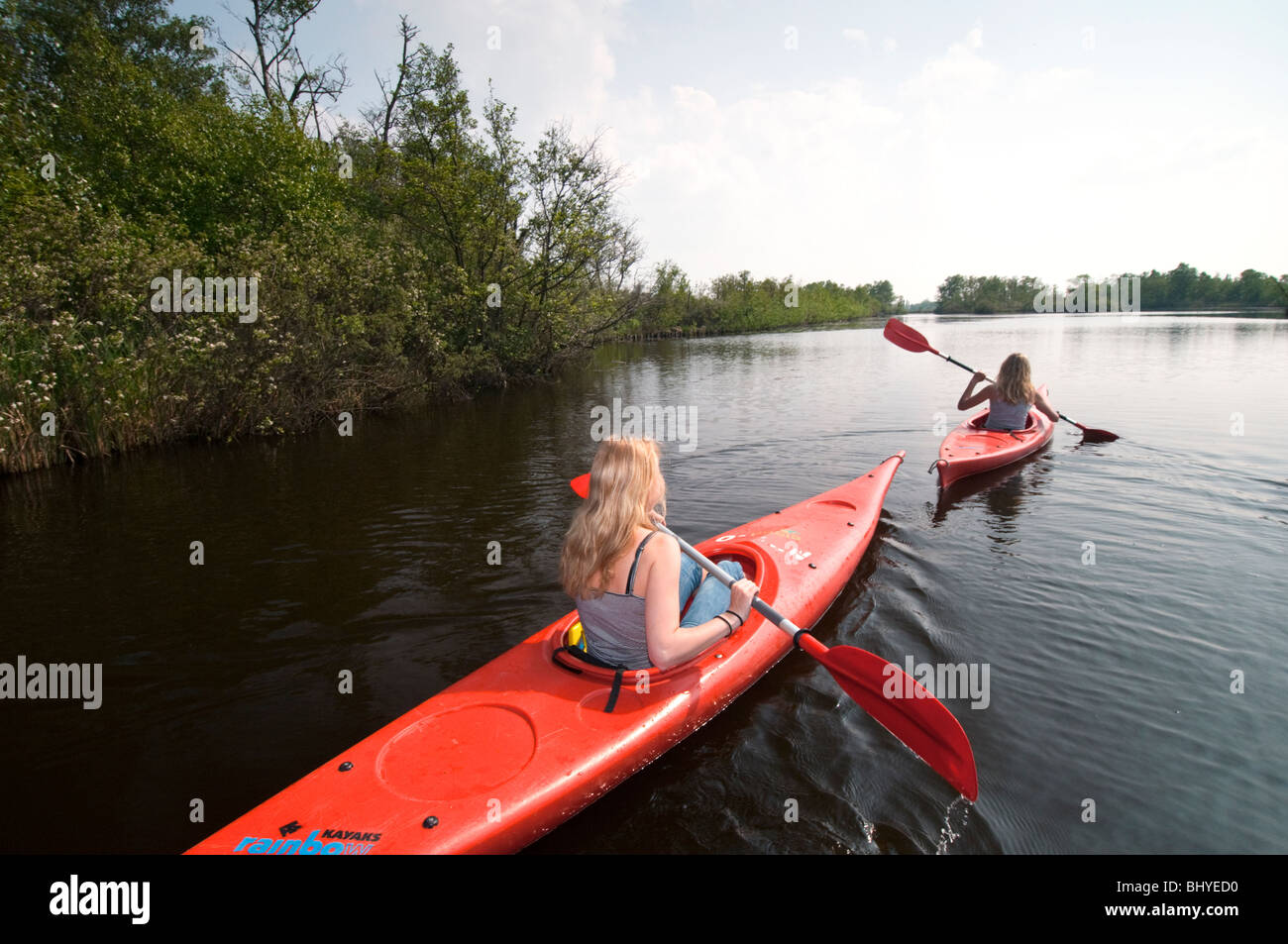 Young girls Kayaking in wilderness and having a lot of fun on a ...