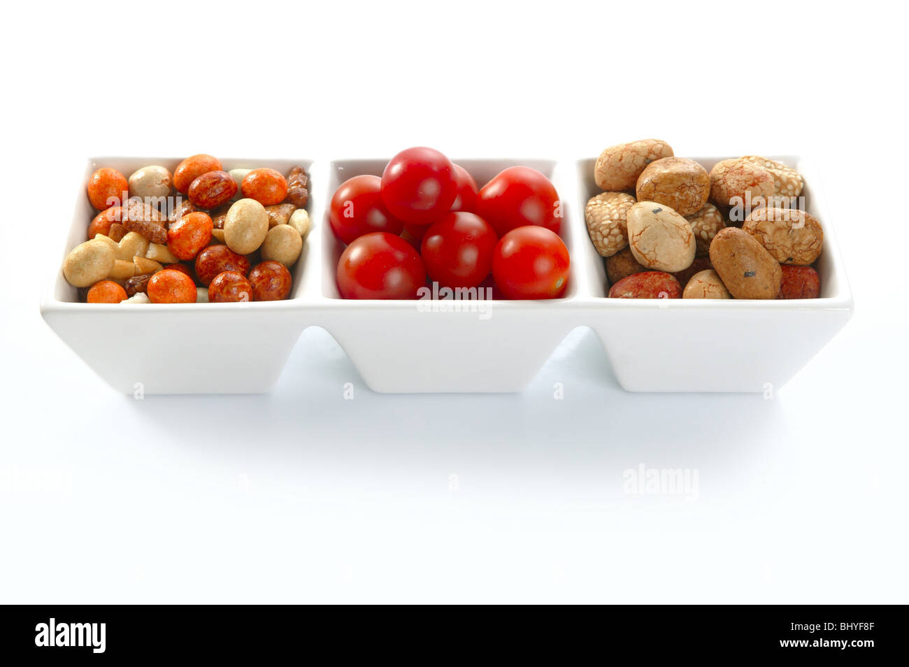 Long triple bowl with varied japanese snacks and tomatoes Stock Photo ...