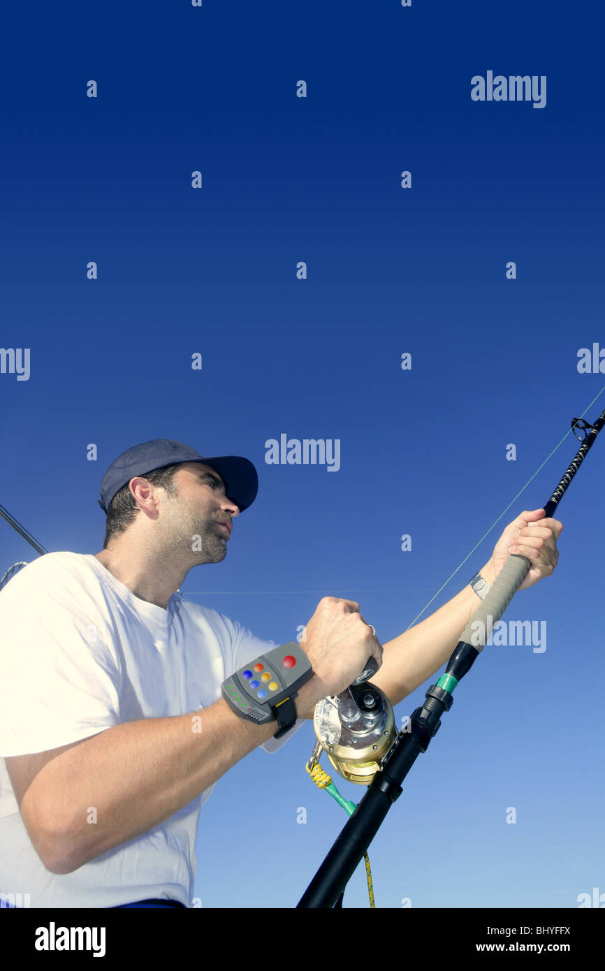 Angler fisherman trolling rod and reel fighting saltwater fish Stock ...