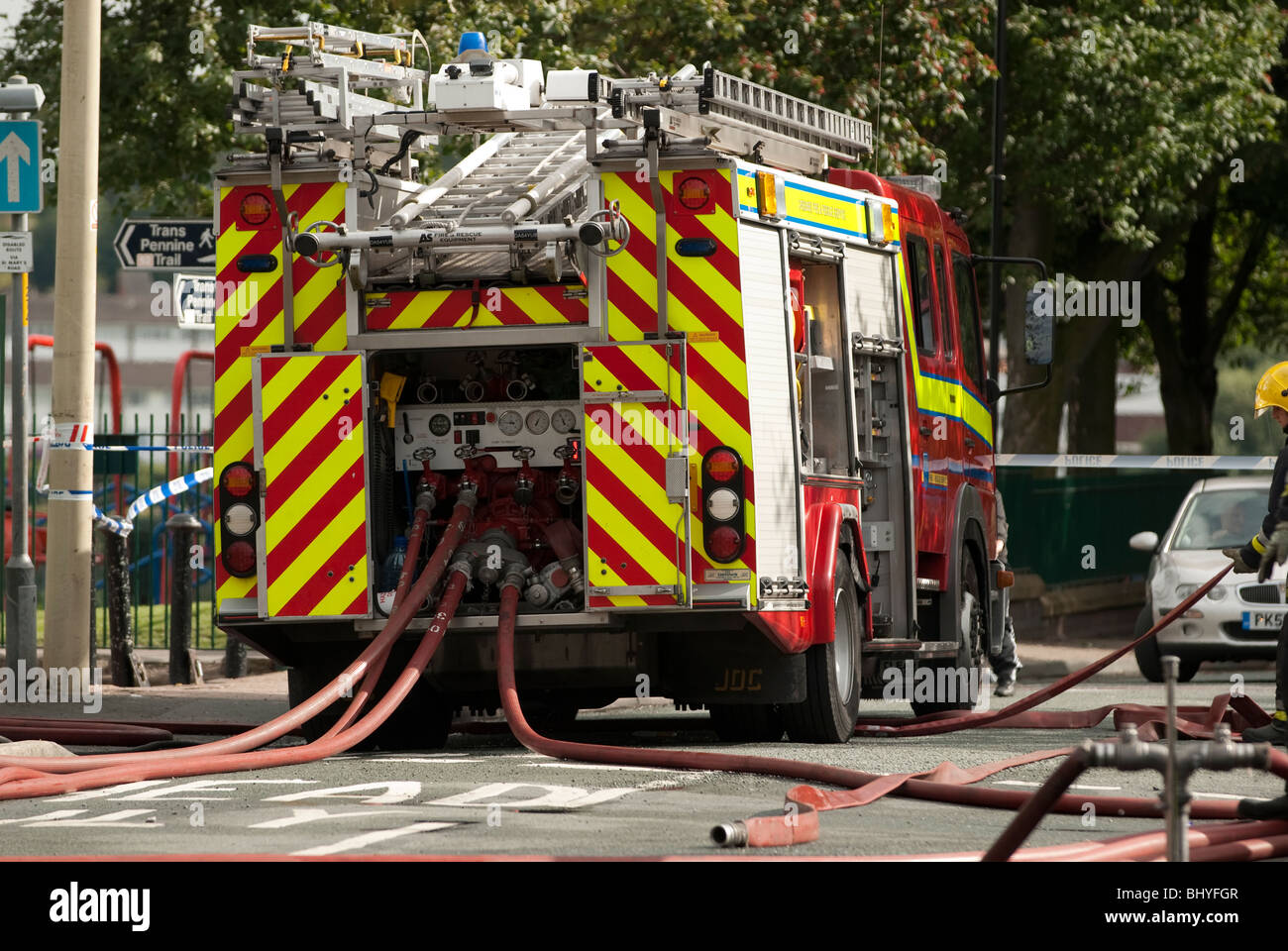 Fire engine with multiple hoses in use at large fire Stock Photo - Alamy