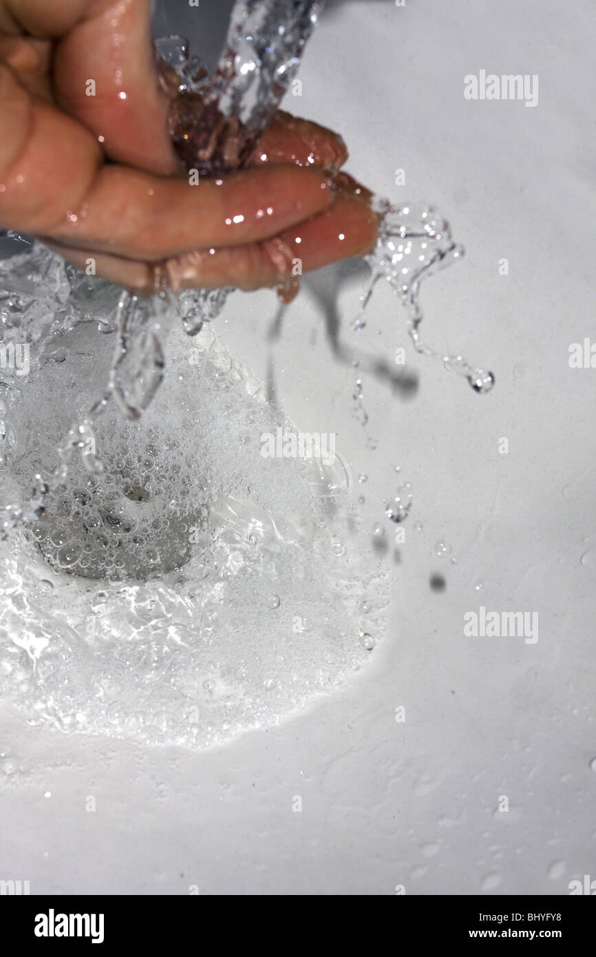 Fingers of the left hand under stream of clear water in sink Stock ...