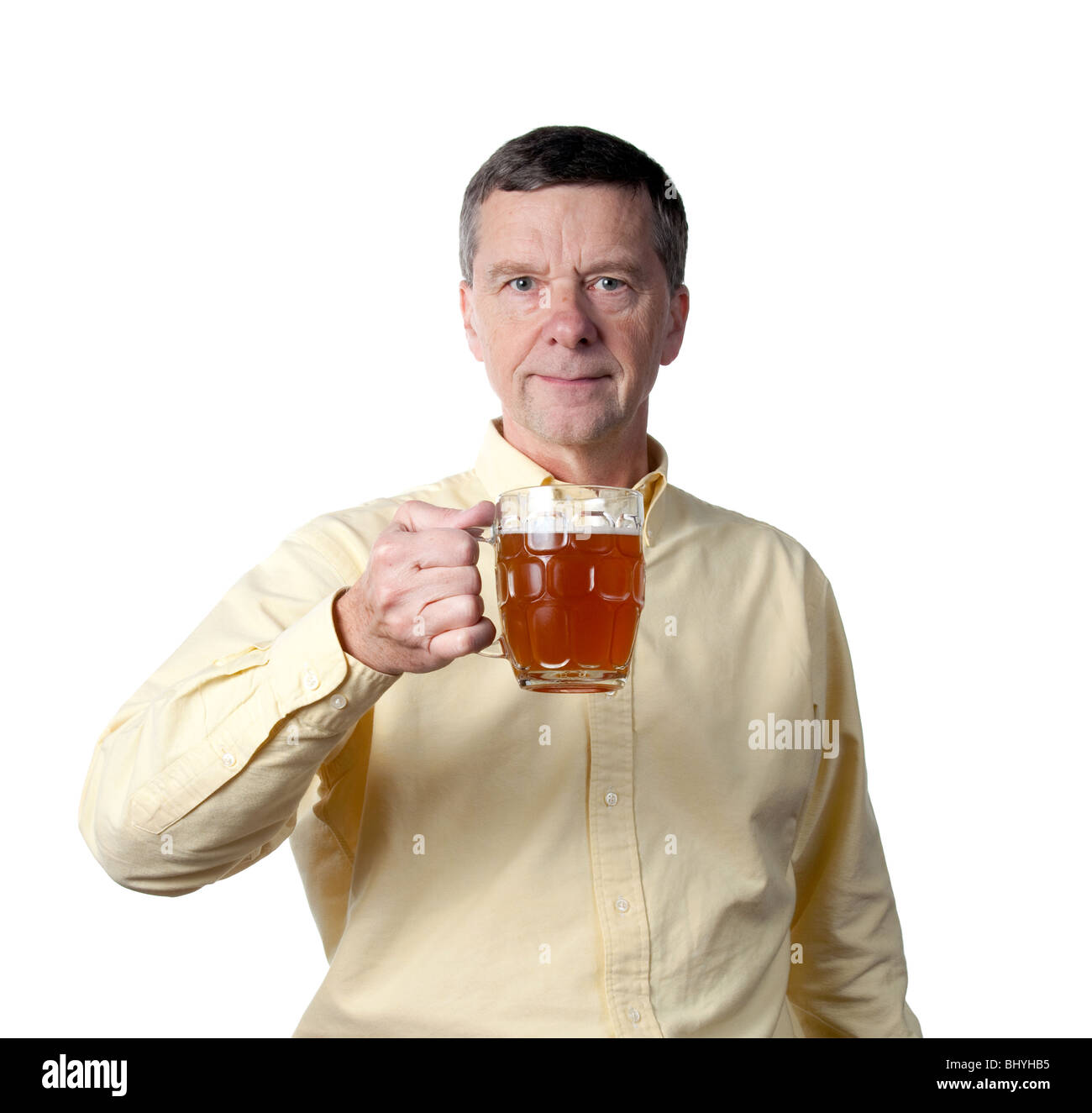Senior male holding a traditional pint glass partially filled with ...