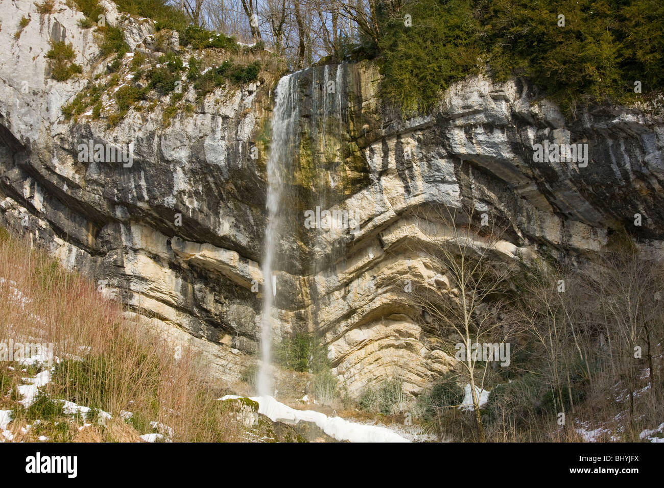 Waterfall over folded Jurassic limestone strata - the Chapeau de ...