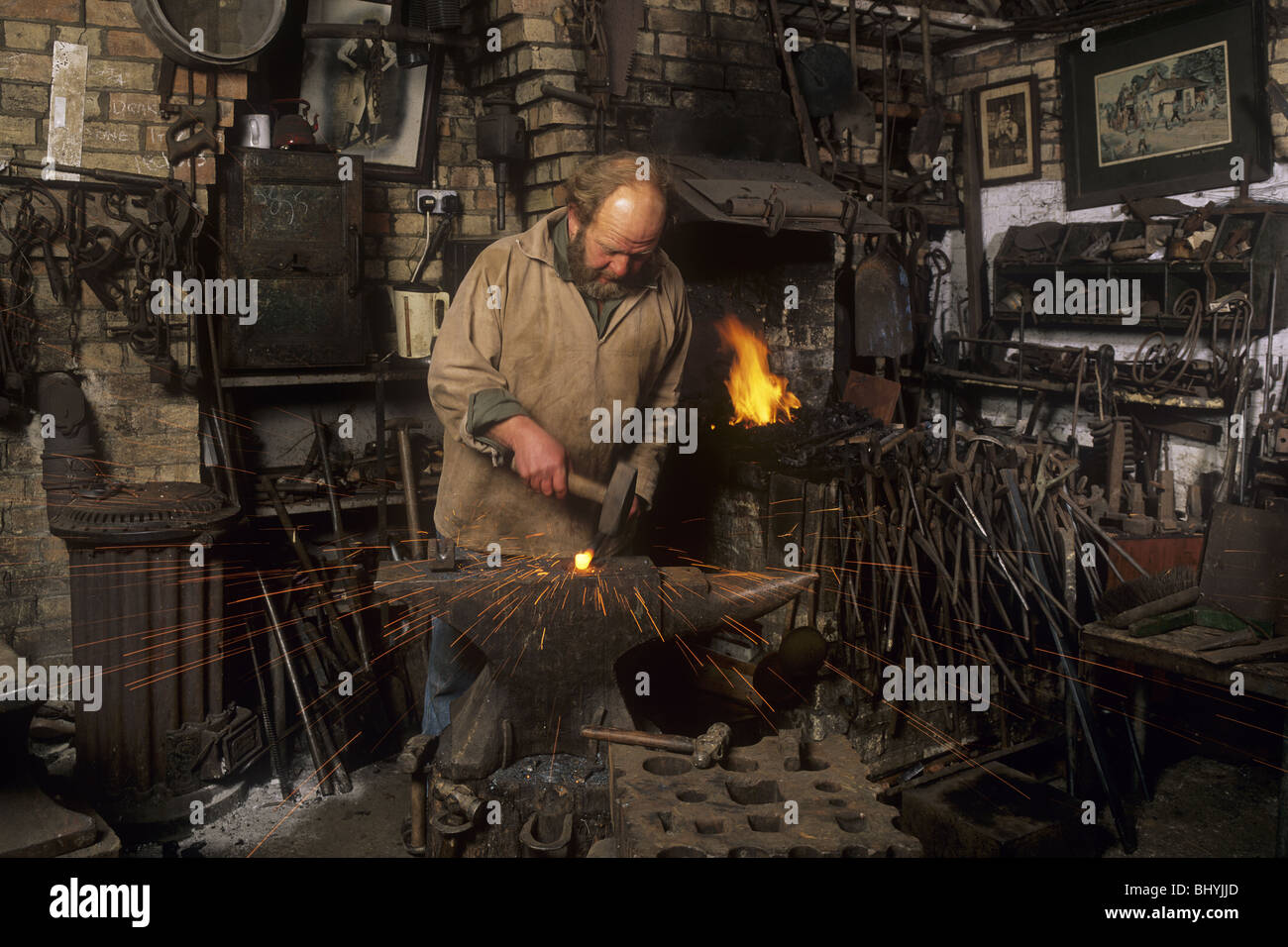 Blacksmith at Work in his village Forge at Mentmore village ...