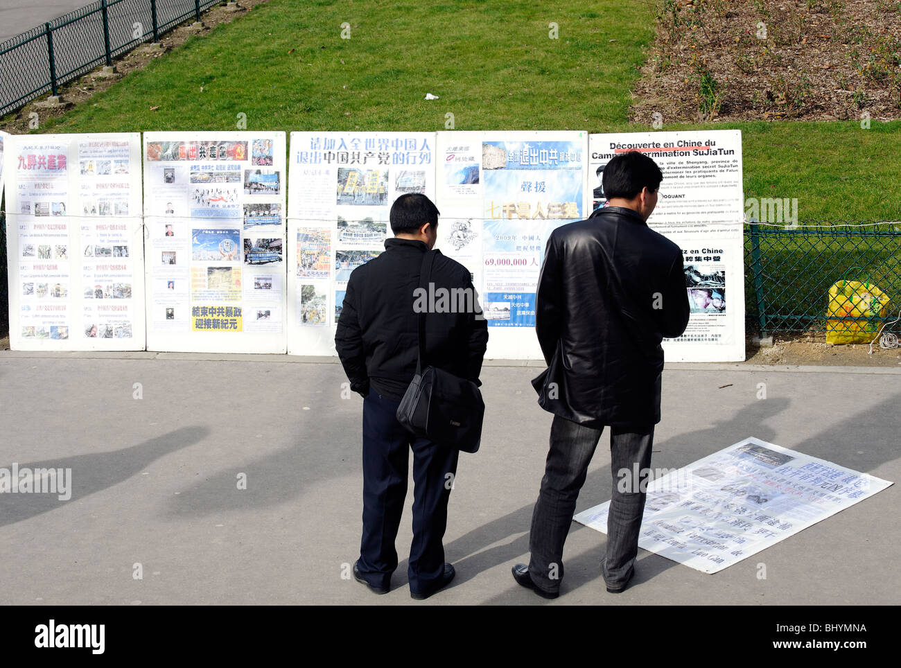 Two men reading protest material in central Paris Stock Photo - Alamy