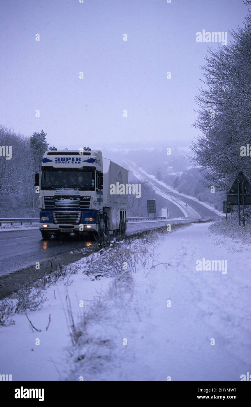lorry travelling through heavy winter snow near Malton Yorkshire UK ...