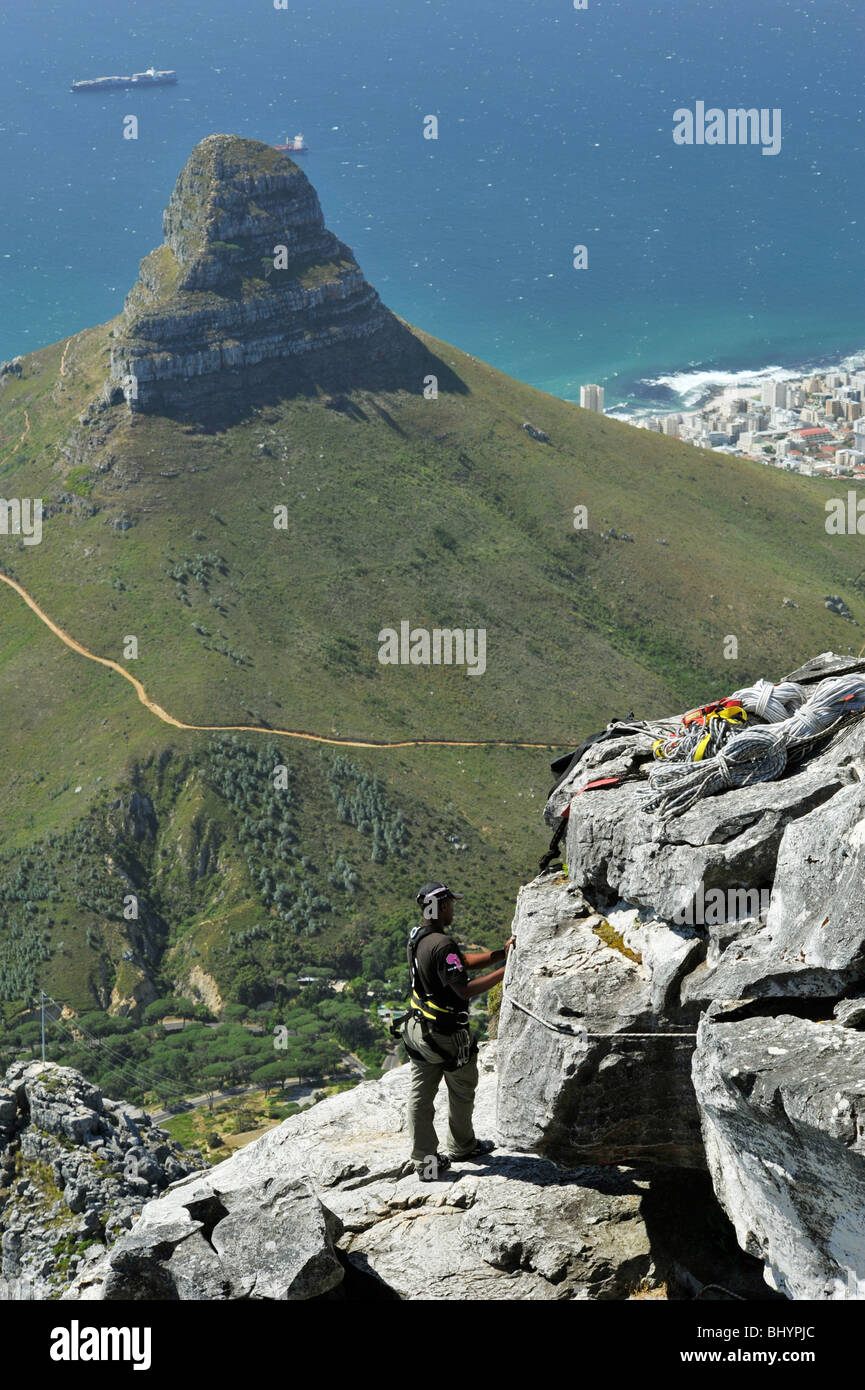 Man in abseiling gear standing on rock Table Mountain Cape Town South ...