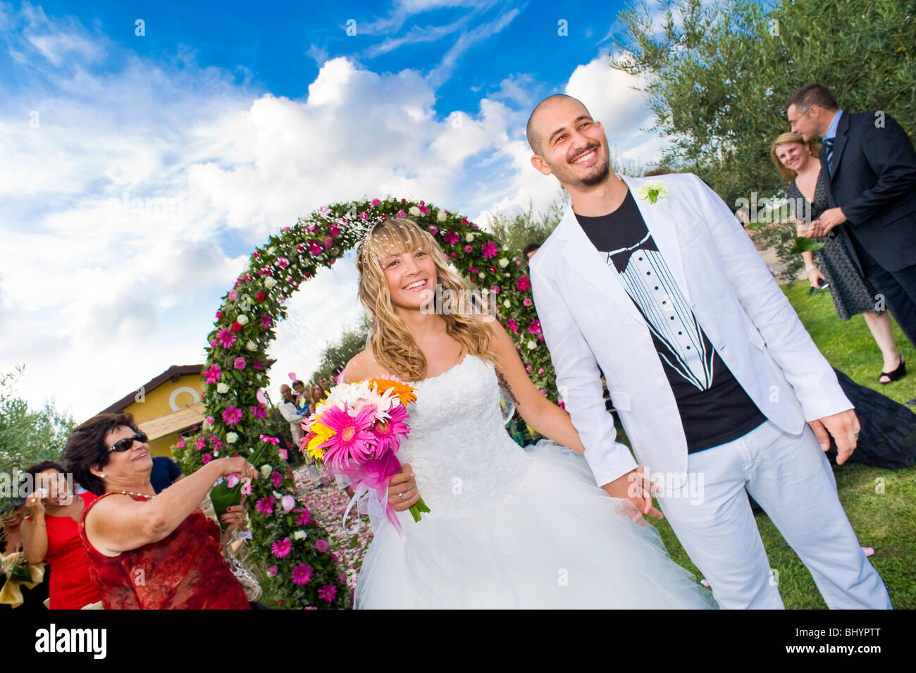 Happy bride and groom during lunch of petals at Italian wedding Stock ...