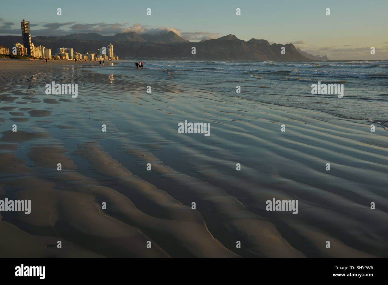 Atmospheric scene of water covered ripples in beach sand The Strand ...