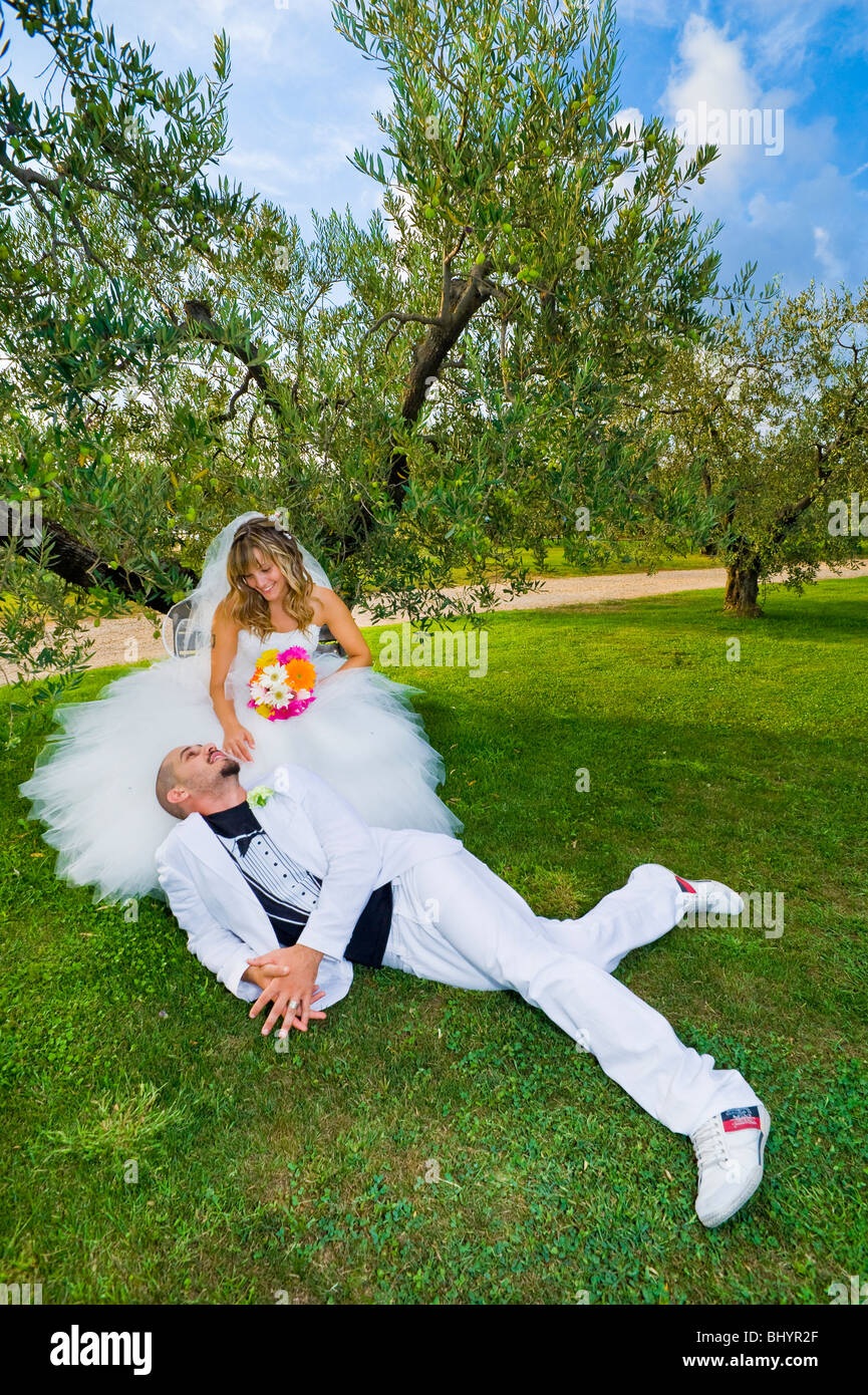 Bride and groom relaxing in lawn Stock Photo - Alamy