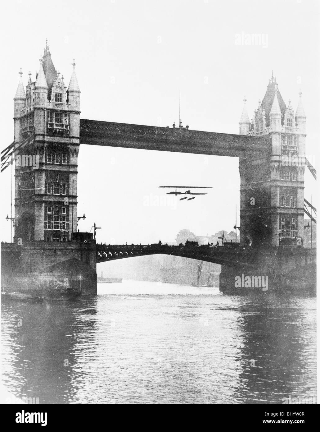 Biplane flying under Tower Bridge, Stepney, Tower Hamlets, London ...