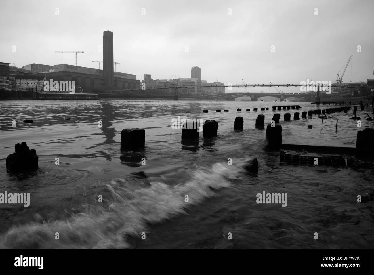 Old pier posts revealed at low tide on the River Thames near Millennium ...