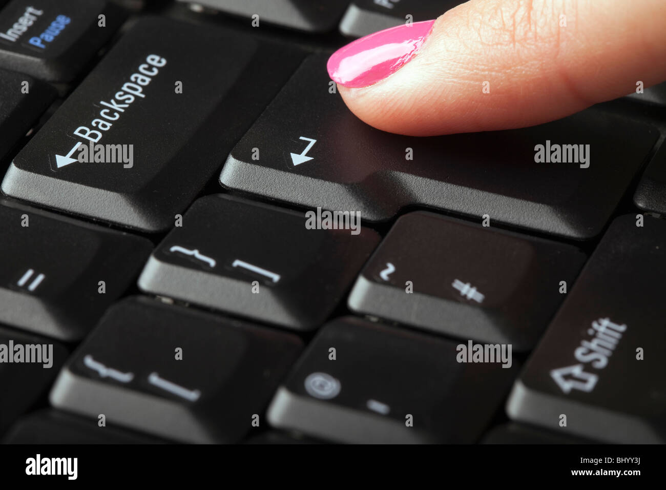 Female finger pressing computer key Stock Photo - Alamy