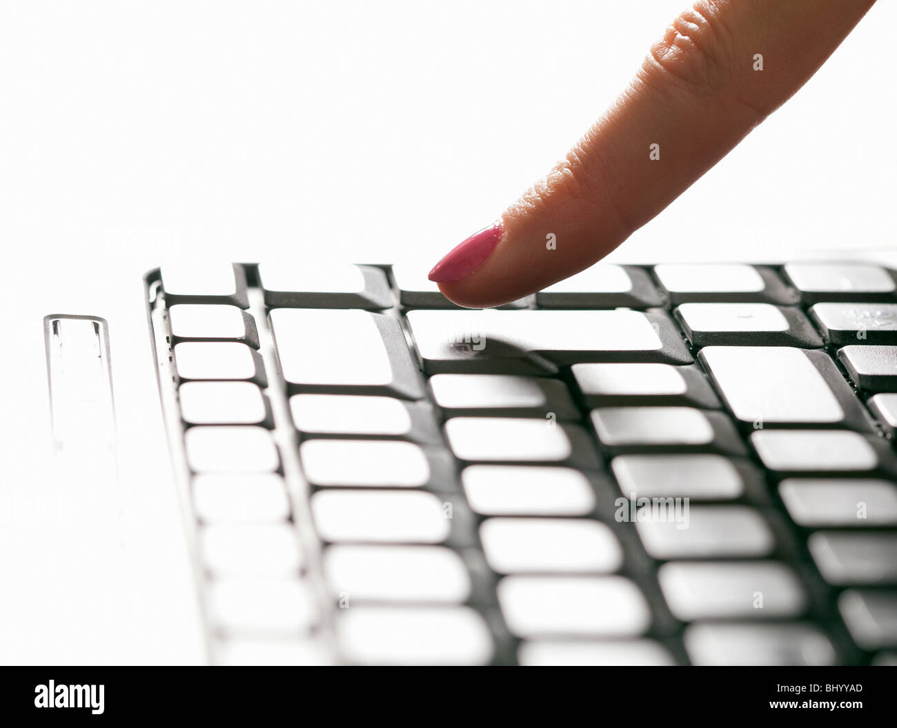 Female finger pressing computer key Stock Photo - Alamy