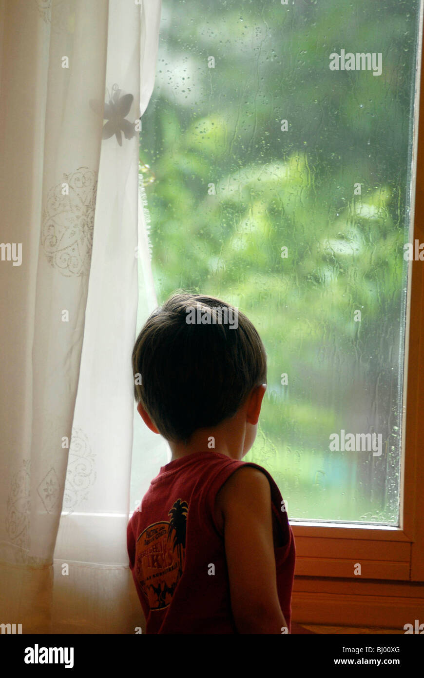 Child at the window Stock Photo - Alamy