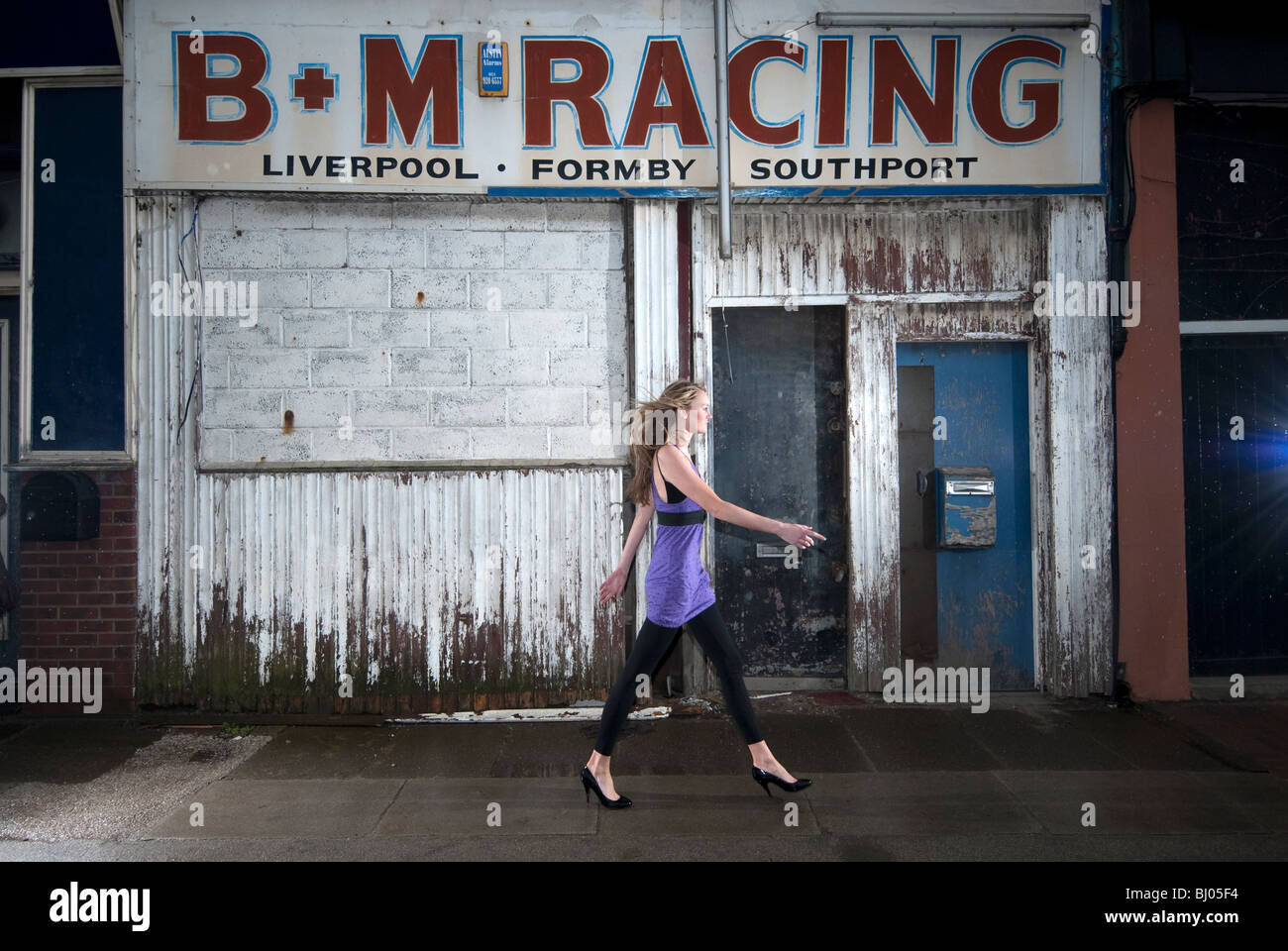 Fashion model walking in front of old Bookmakers shop. FULLY MODEL ...