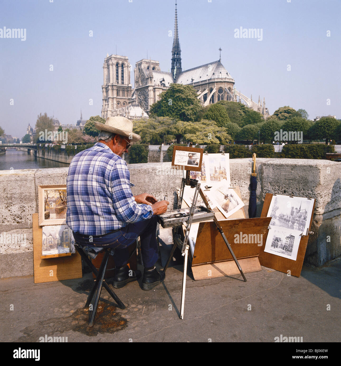 Artist on bridge overlooking the Notre Dame, Paris, France Stock Photo ...