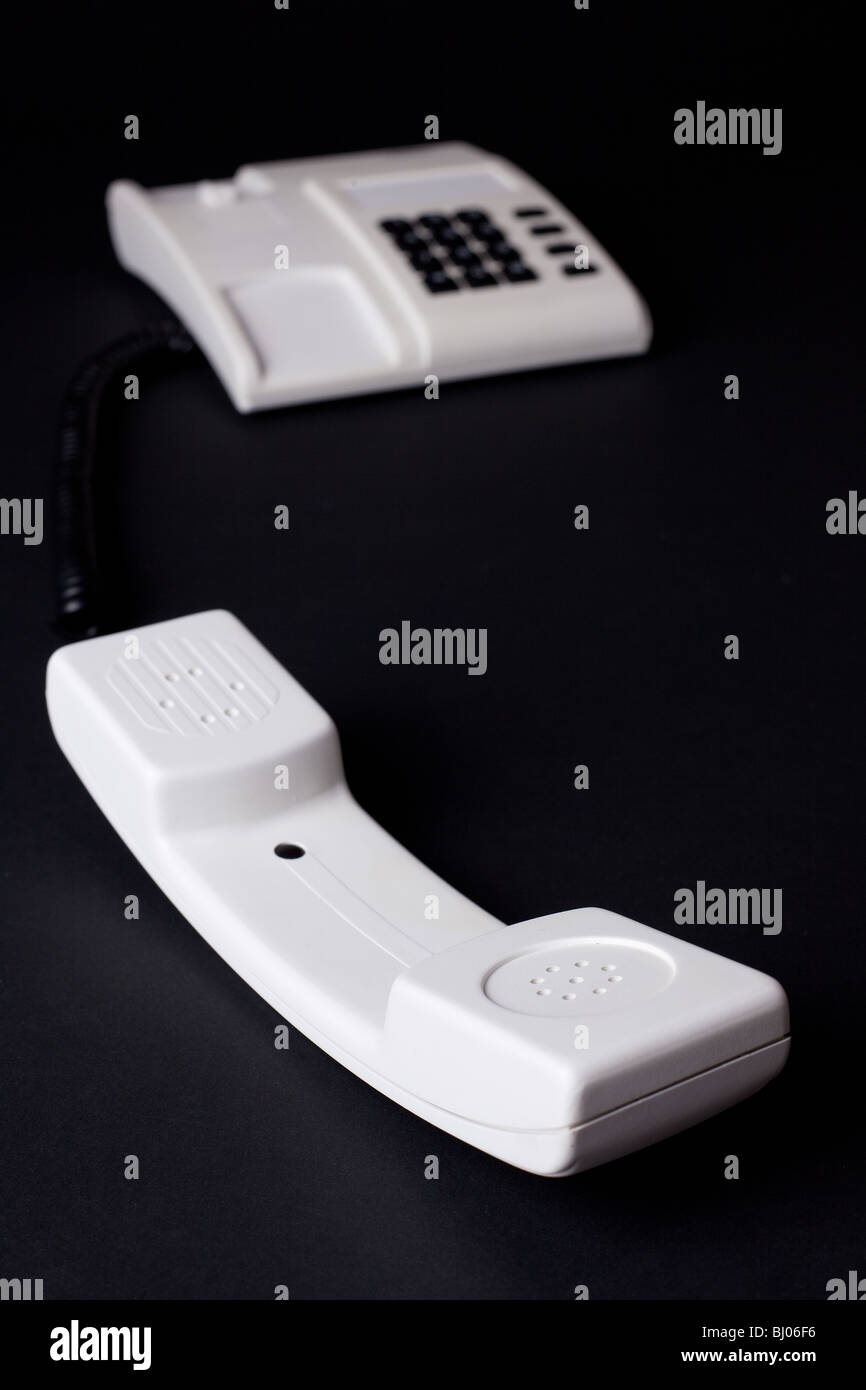 the white telephone on black background Stock Photo - Alamy