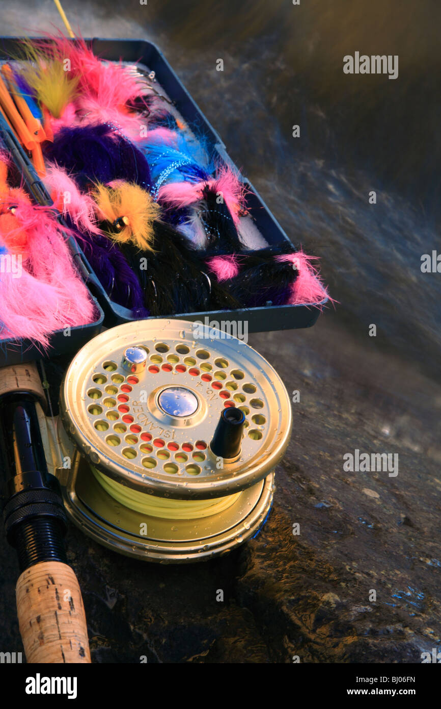 Fly rod and fly box on rocks in river, Bulkley river, Smithers, British ...