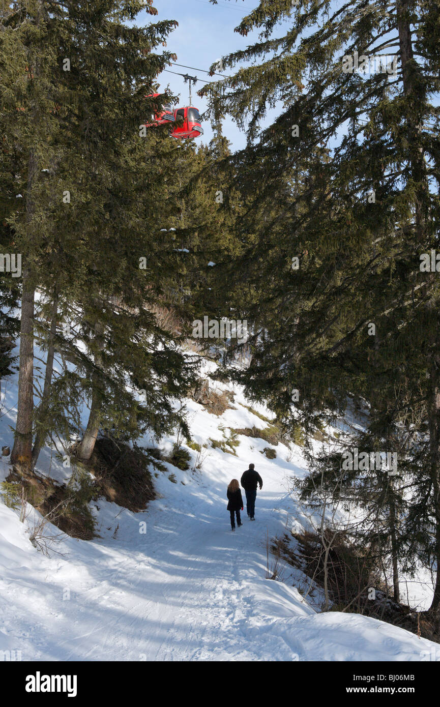 Walkers on a path through the woods above the resort centre, Crans ...