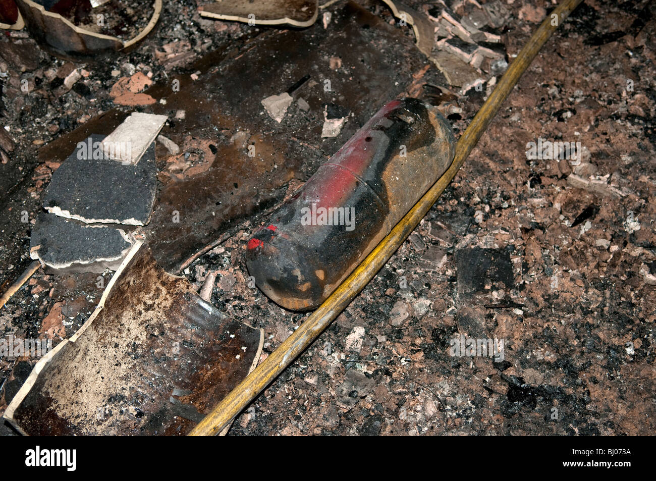 burnt fire extinguisher in remains and debris from large fire Stock ...
