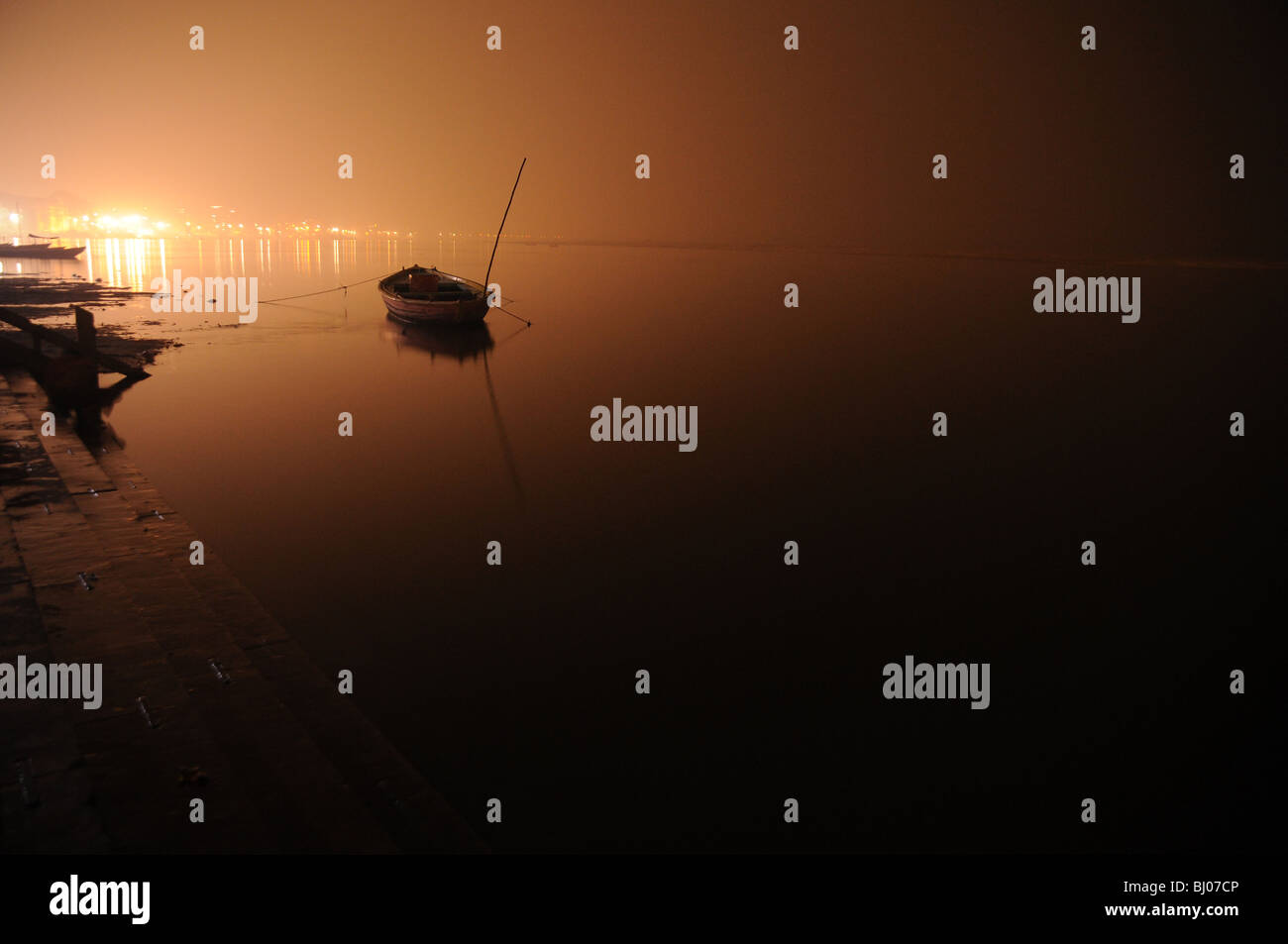A boat floating silently and peacefully on the Ganges river in Varanasi ...