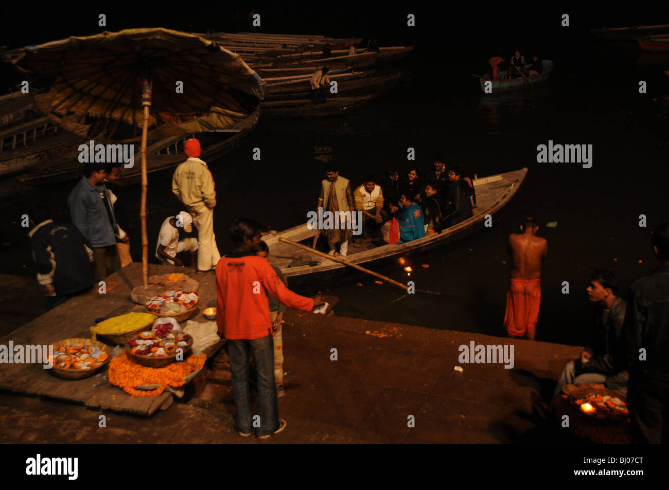 A family pull into port on one of Varanasi's sacred ghats on the River ...