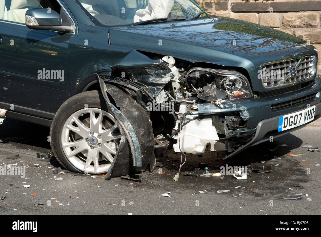 Crushed car at car crash scene - front wheel Stock Photo - Alamy