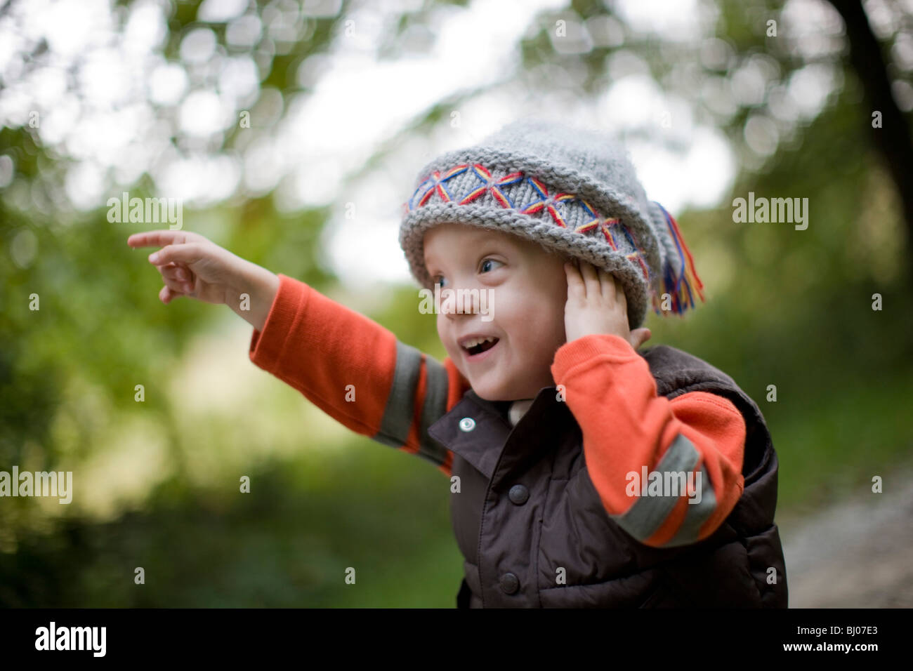 Young boy excited and pointing at something outside Stock Photo - Alamy