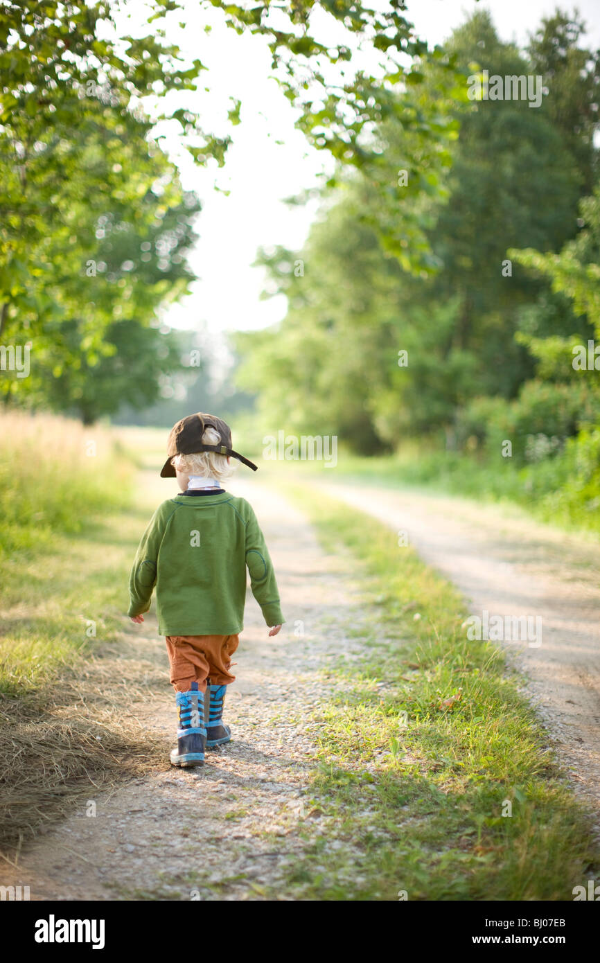 Boy Walking Alone On Road