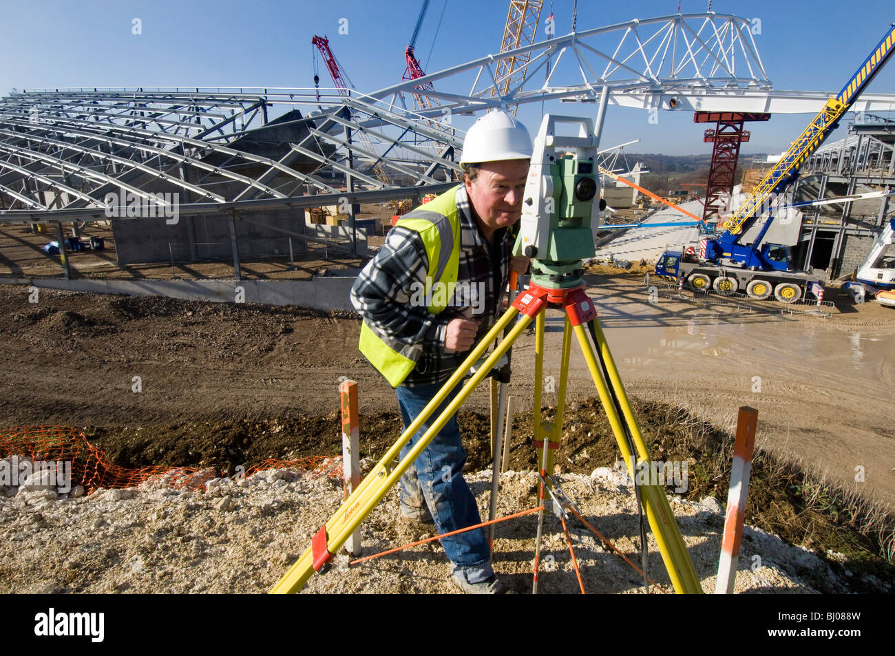 Surveyor taking readings on a building site Stock Photo - Alamy