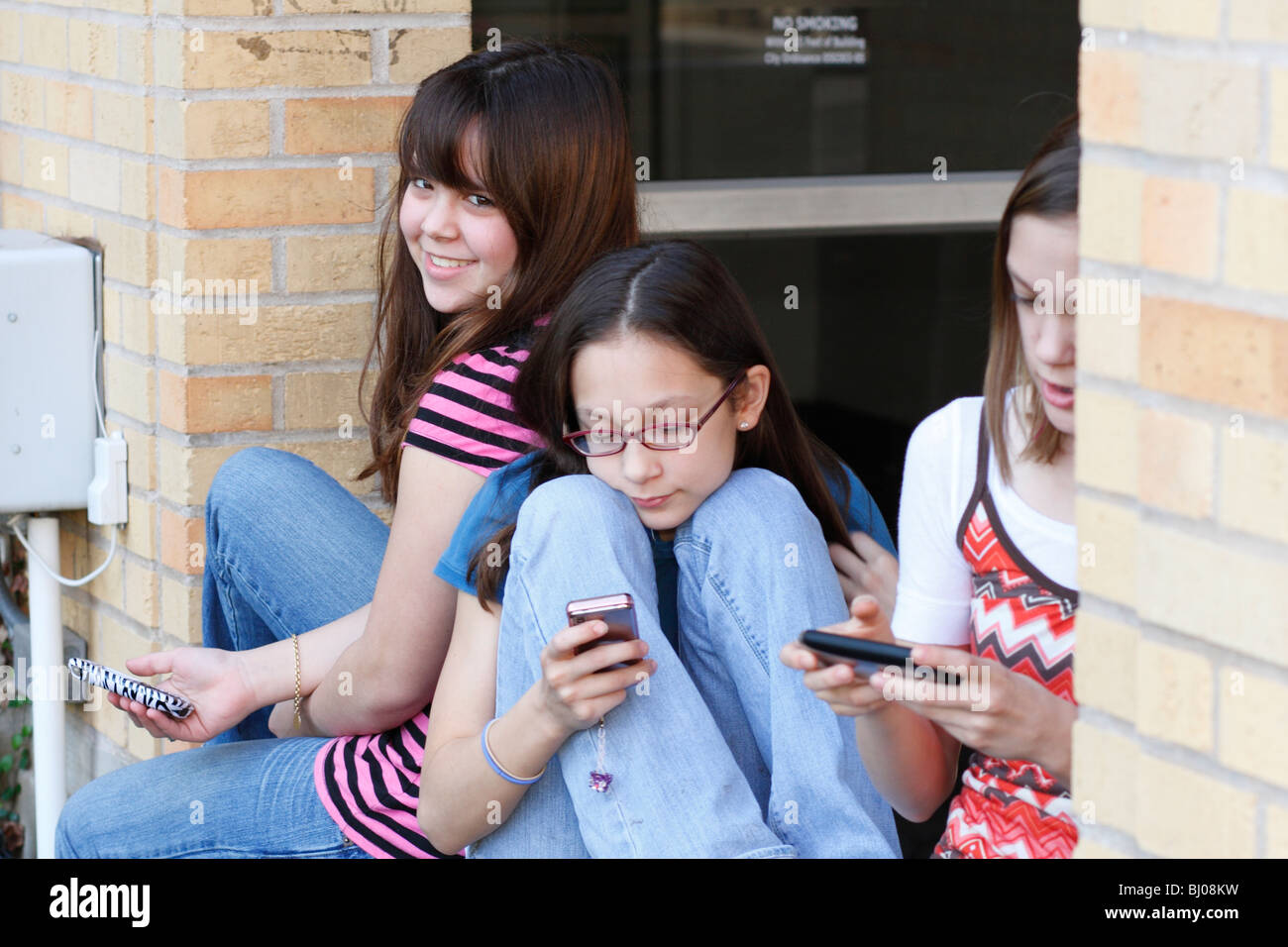 Teen girls texting and having fun Stock Photo - Alamy