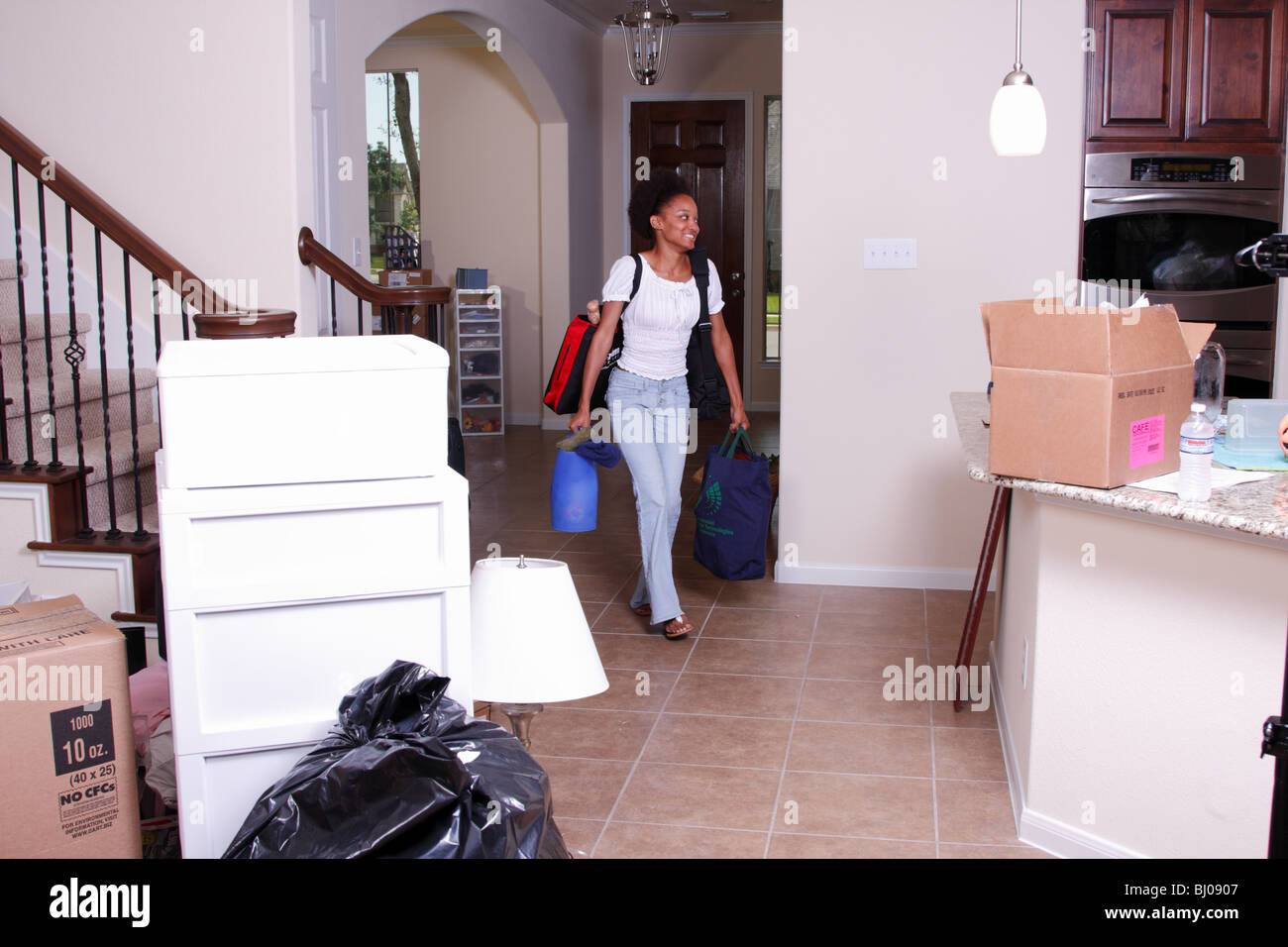 Young woman moving back home Stock Photo - Alamy