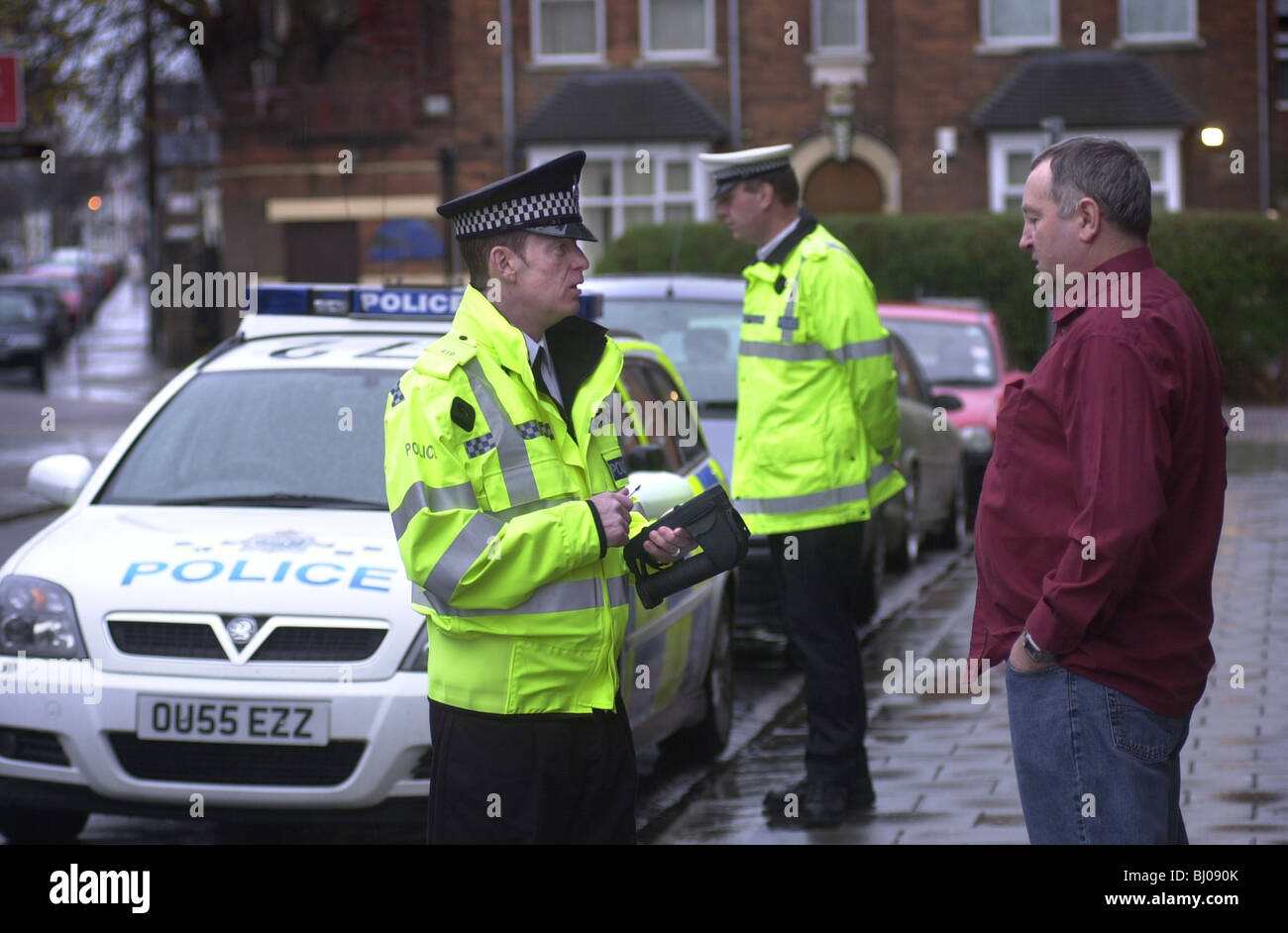 Police on the street use an electronic machine that reads and analises ...
