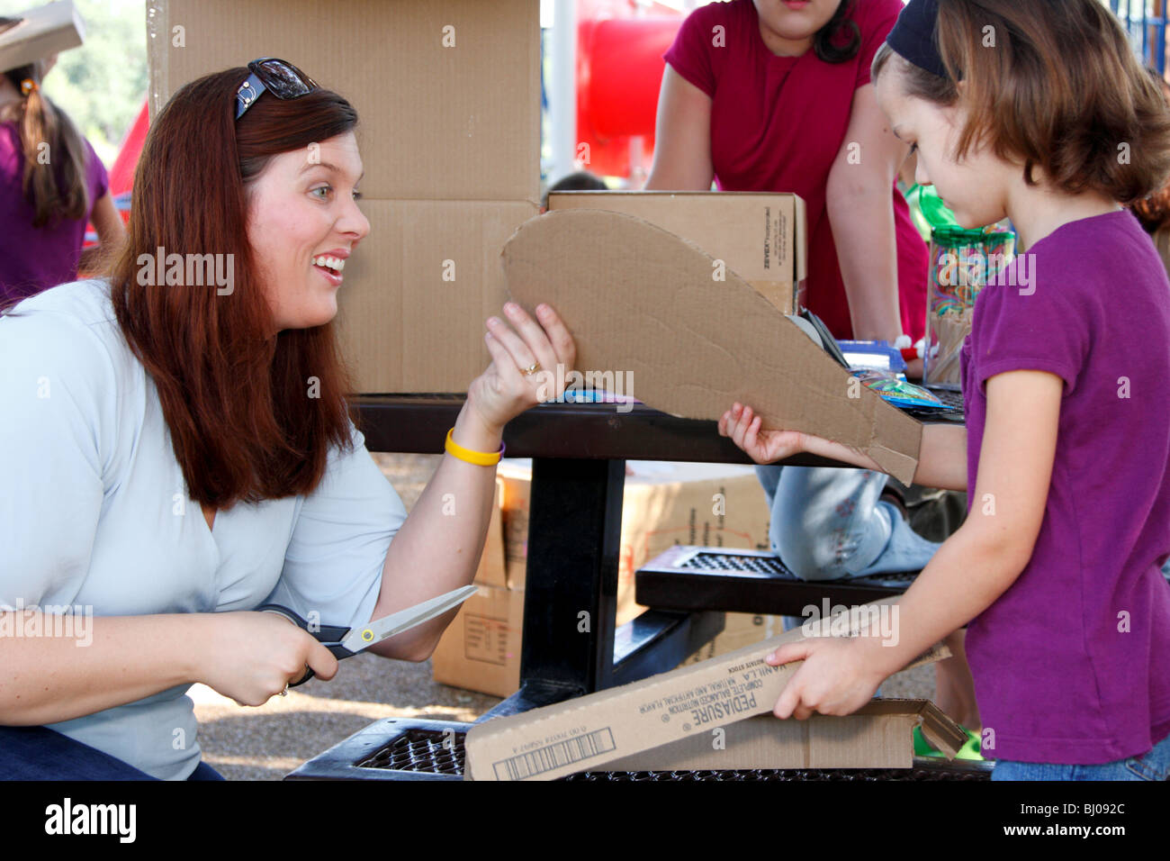 Teacher helping student with project Stock Photo - Alamy