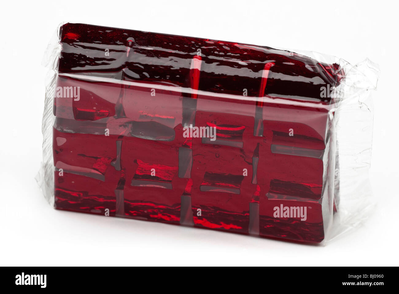 Block of squared jelly wrapped in cellophane Stock Photo - Alamy