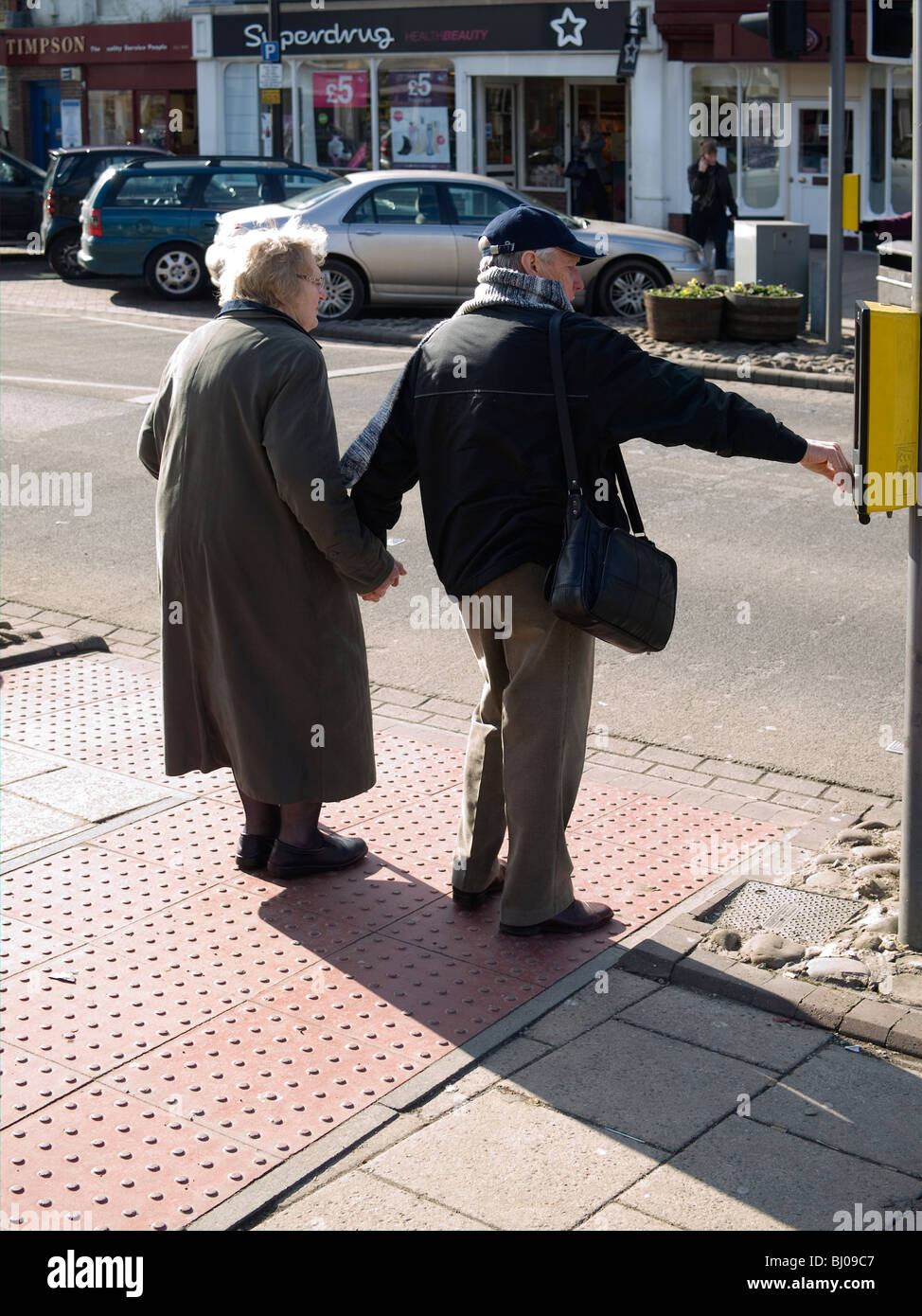 Helping old lady cross road hi-res stock photography and images - Alamy