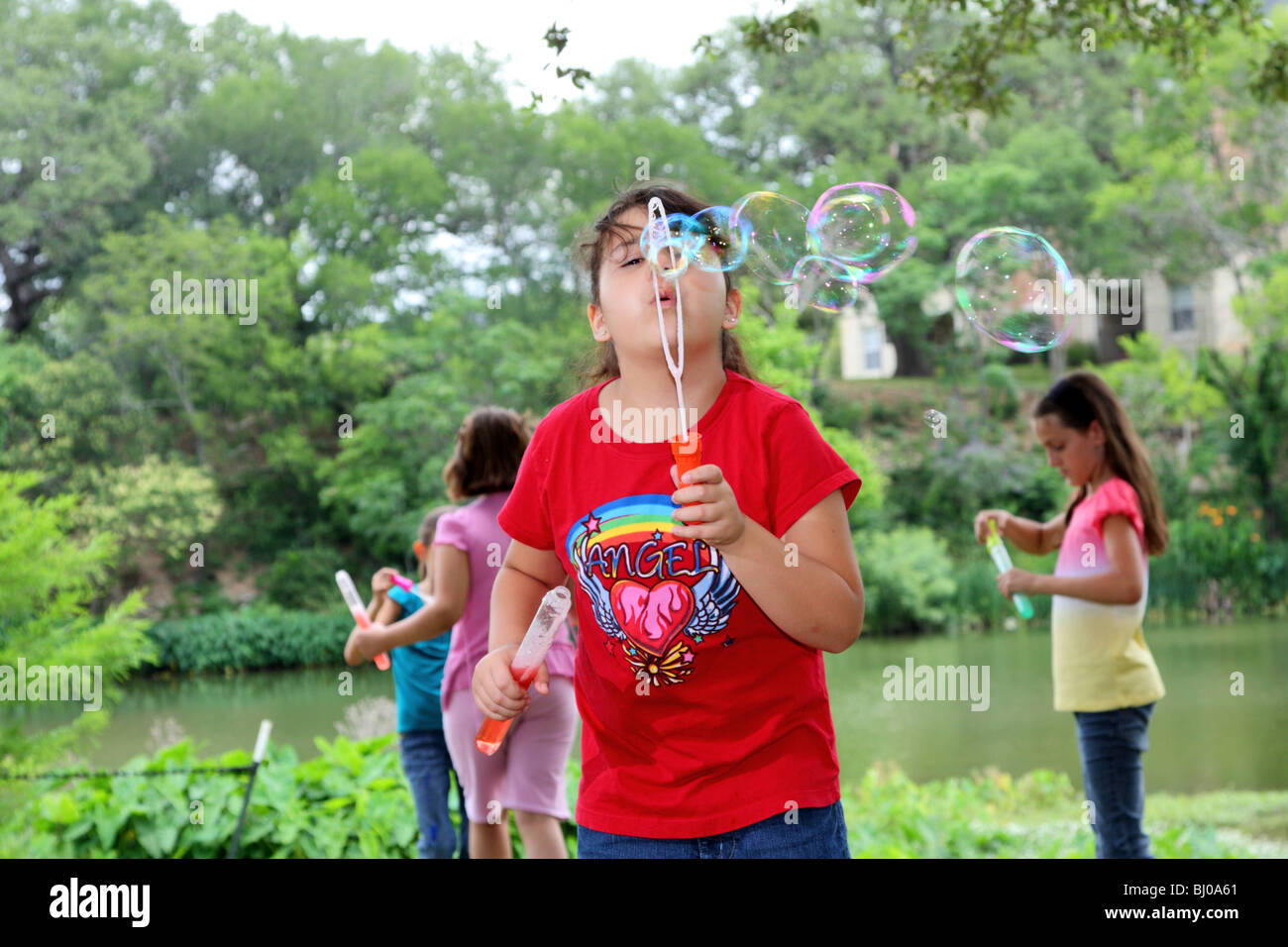kids having fun playing with bubbles Stock Photo - Alamy
