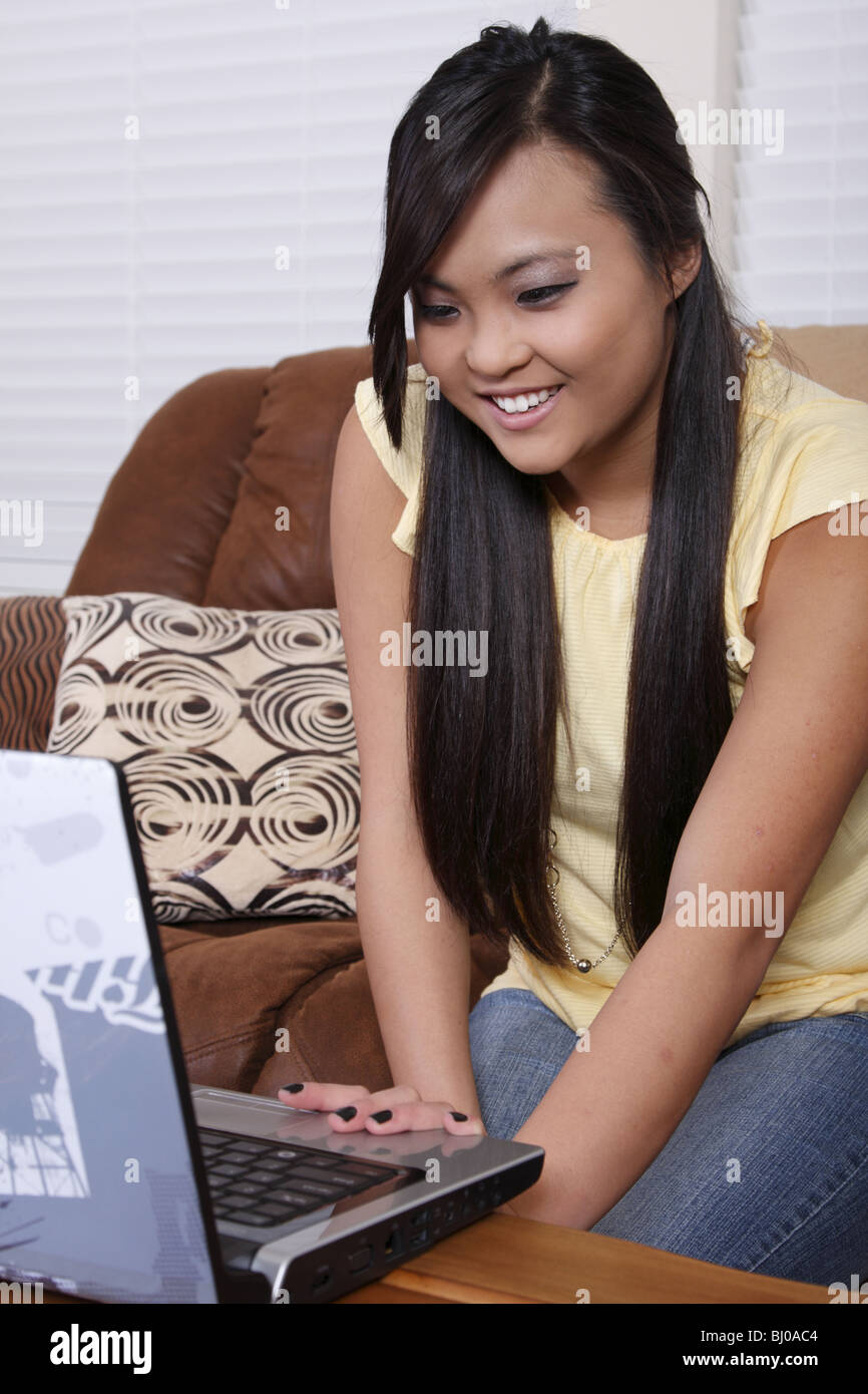 Teen girl using a laptop computer Stock Photo - Alamy