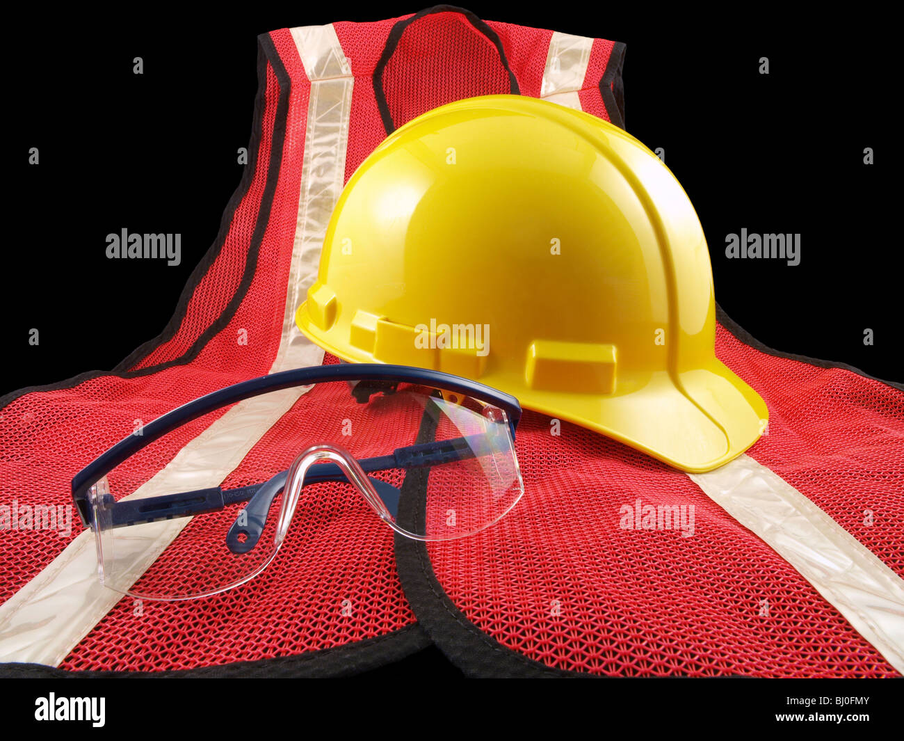 Trio of personal safety equipment. Hard hat, glasses and orange vest ...