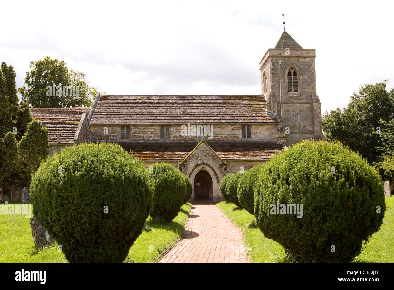 An old church with bushes and trees Stock Photo - Alamy