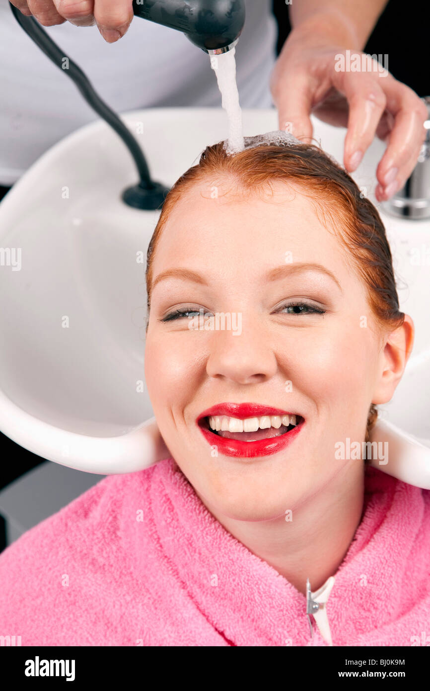 young woman at hair salon getting her hair washed Stock Photo - Alamy