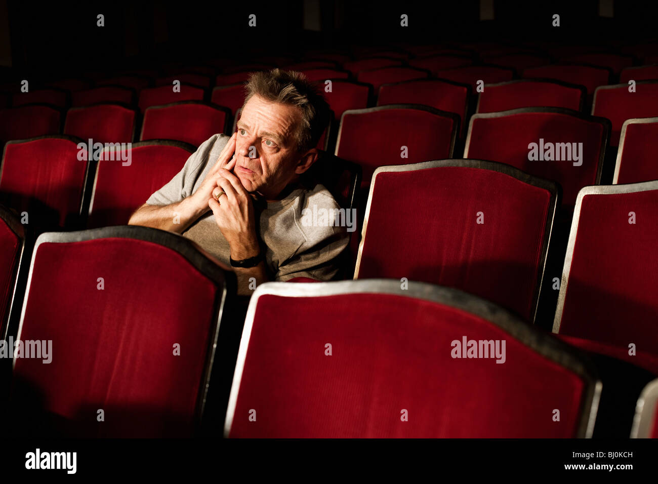 portrait of spectator watching theatre play Stock Photo - Alamy