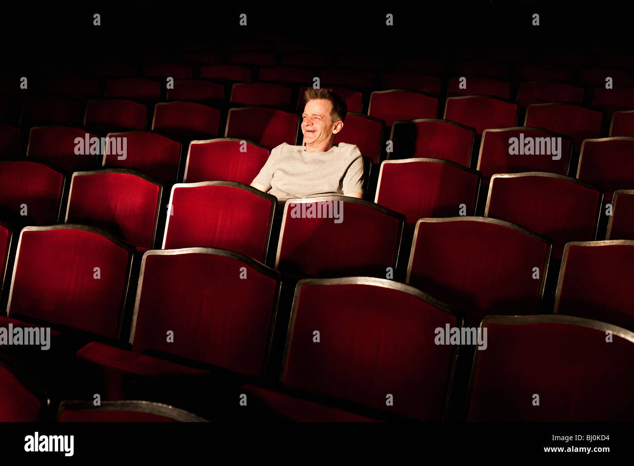 portrait of spectator watching theatre play Stock Photo - Alamy