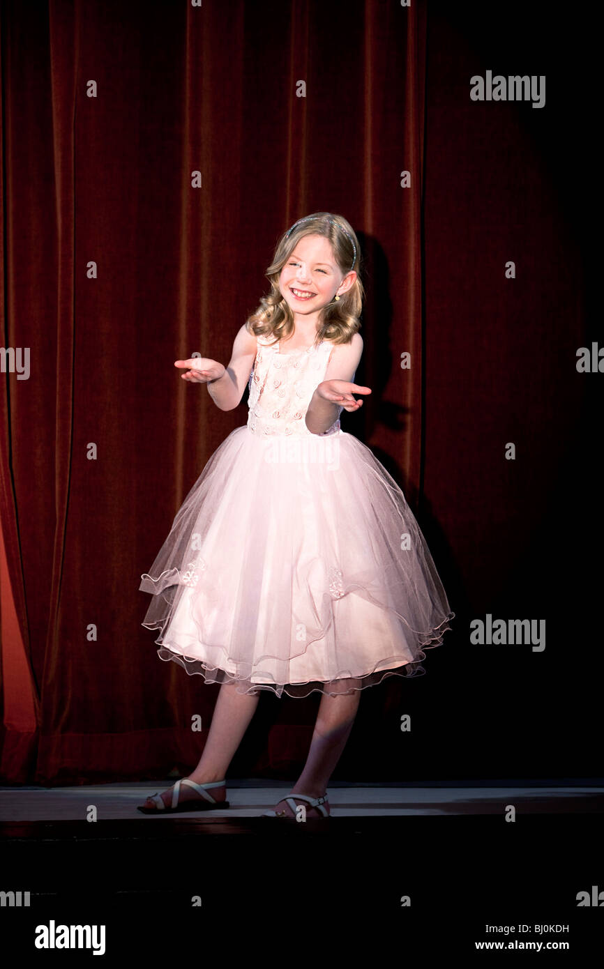 young girl in white dress performing on stage Stock Photo - Alamy