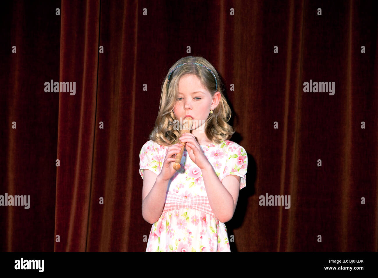 young girl playing recorder on stage Stock Photo - Alamy