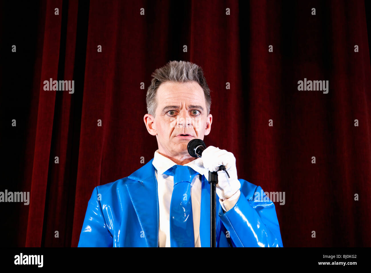 portrait of comedian performing on stage Stock Photo - Alamy