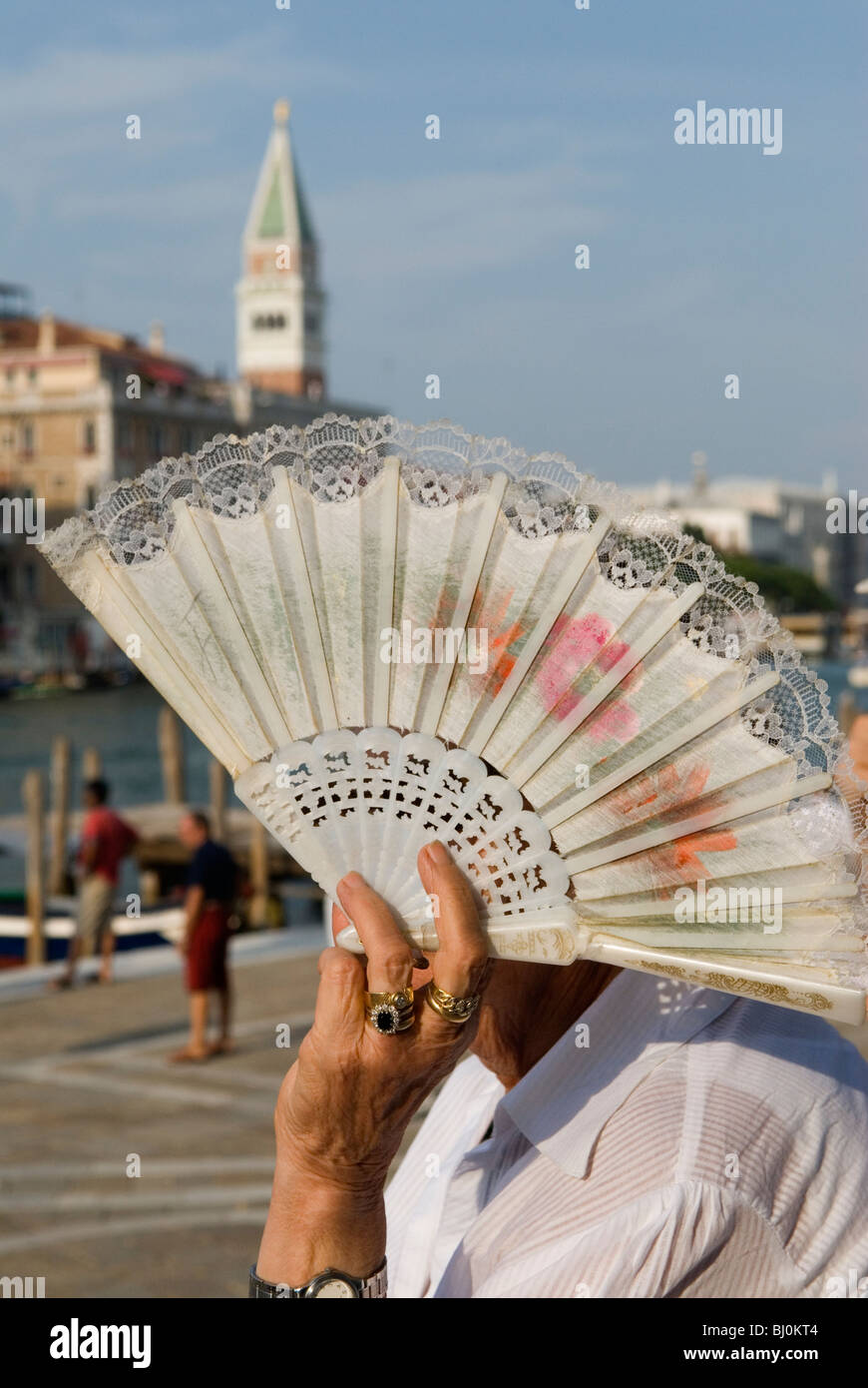 Venetian fan, Venice Italy. Woman with fan shading her face. San Marco ...