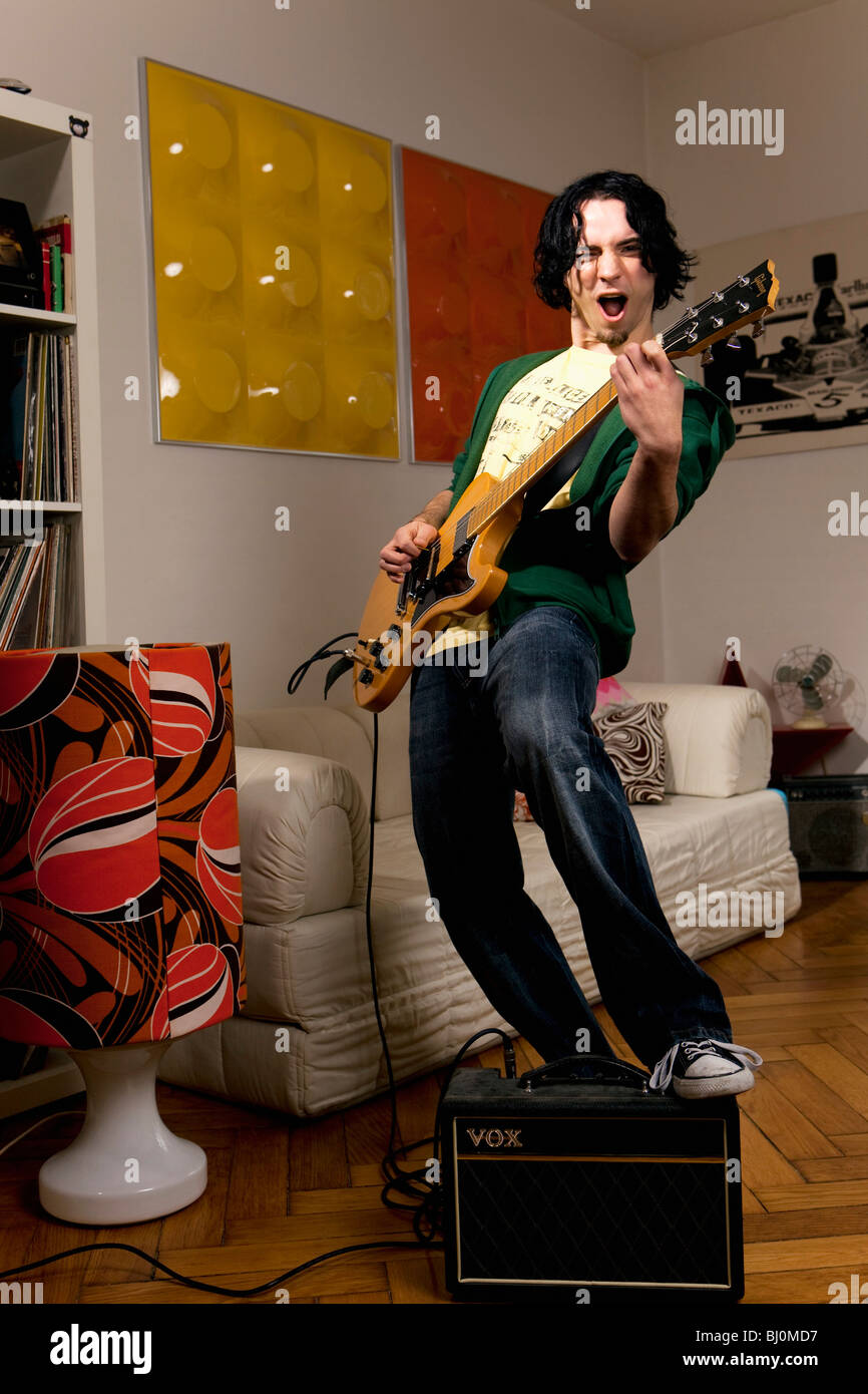 young man playing electric guitar Stock Photo - Alamy